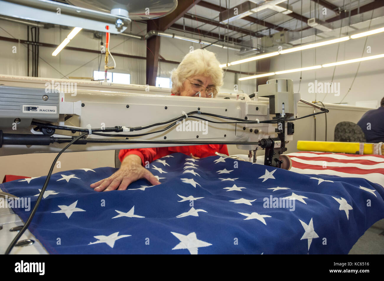 Woman sewing american flag in factory Stock Photo - Alamy