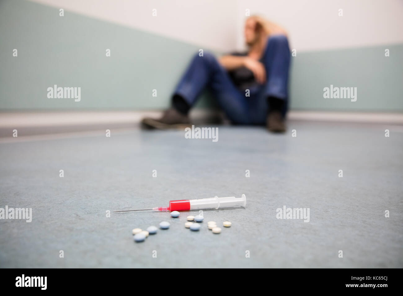 Drug Addicted Person With Syringe And Pills On The Floor Stock Photo ...