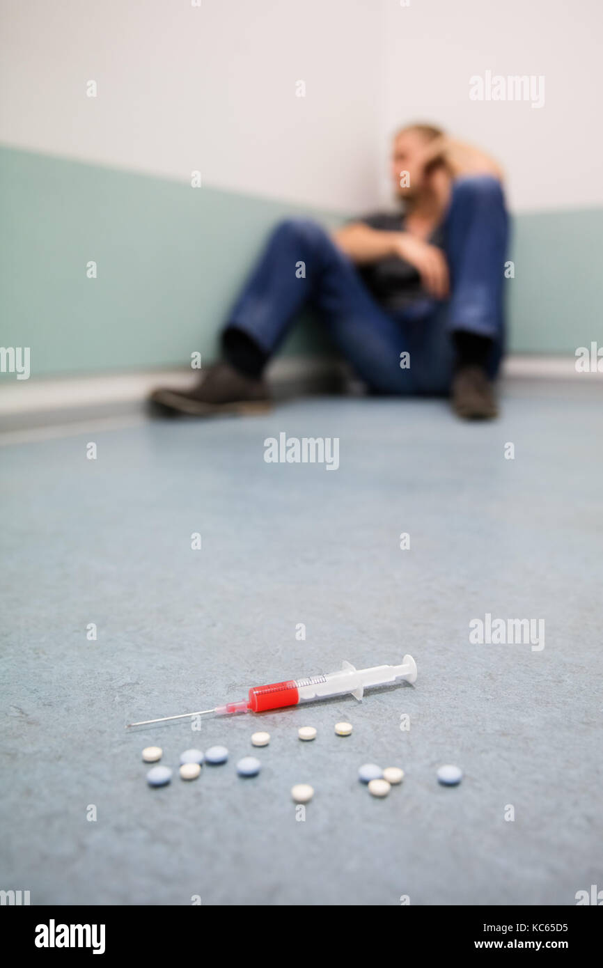 Drug Addicted Person With Syringe And Pills On The Floor Stock Photo ...