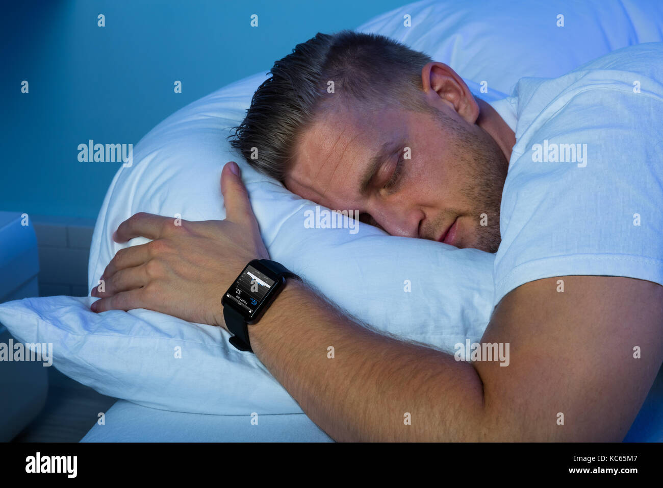 Man Sleeping With Smart Watch In His Hand Showing Heartbeat Rate Stock ...