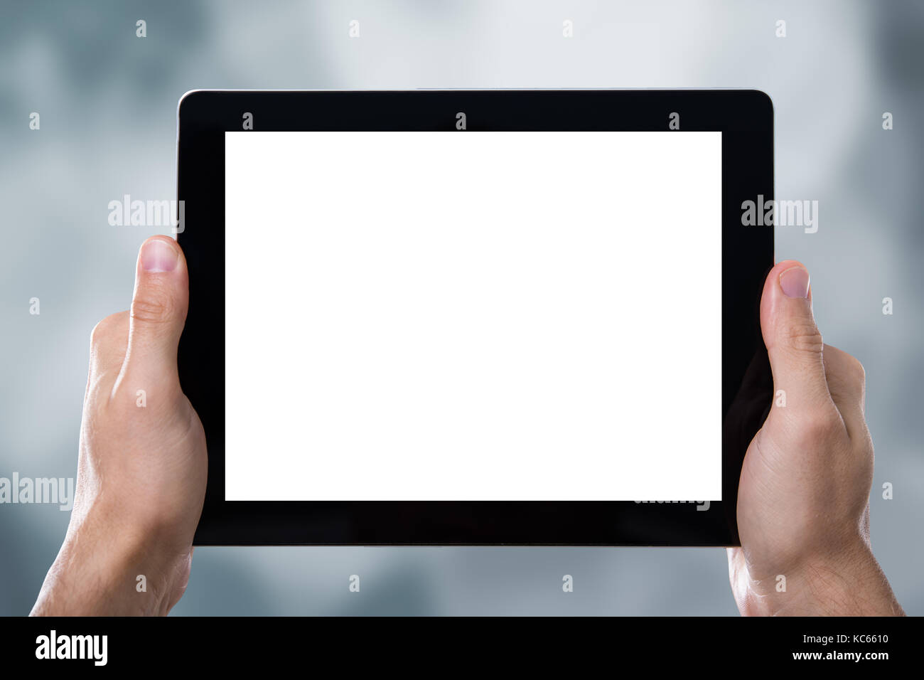 Close-up Of Hands Holding Digital Tablet With A Blank Screen Stock ...