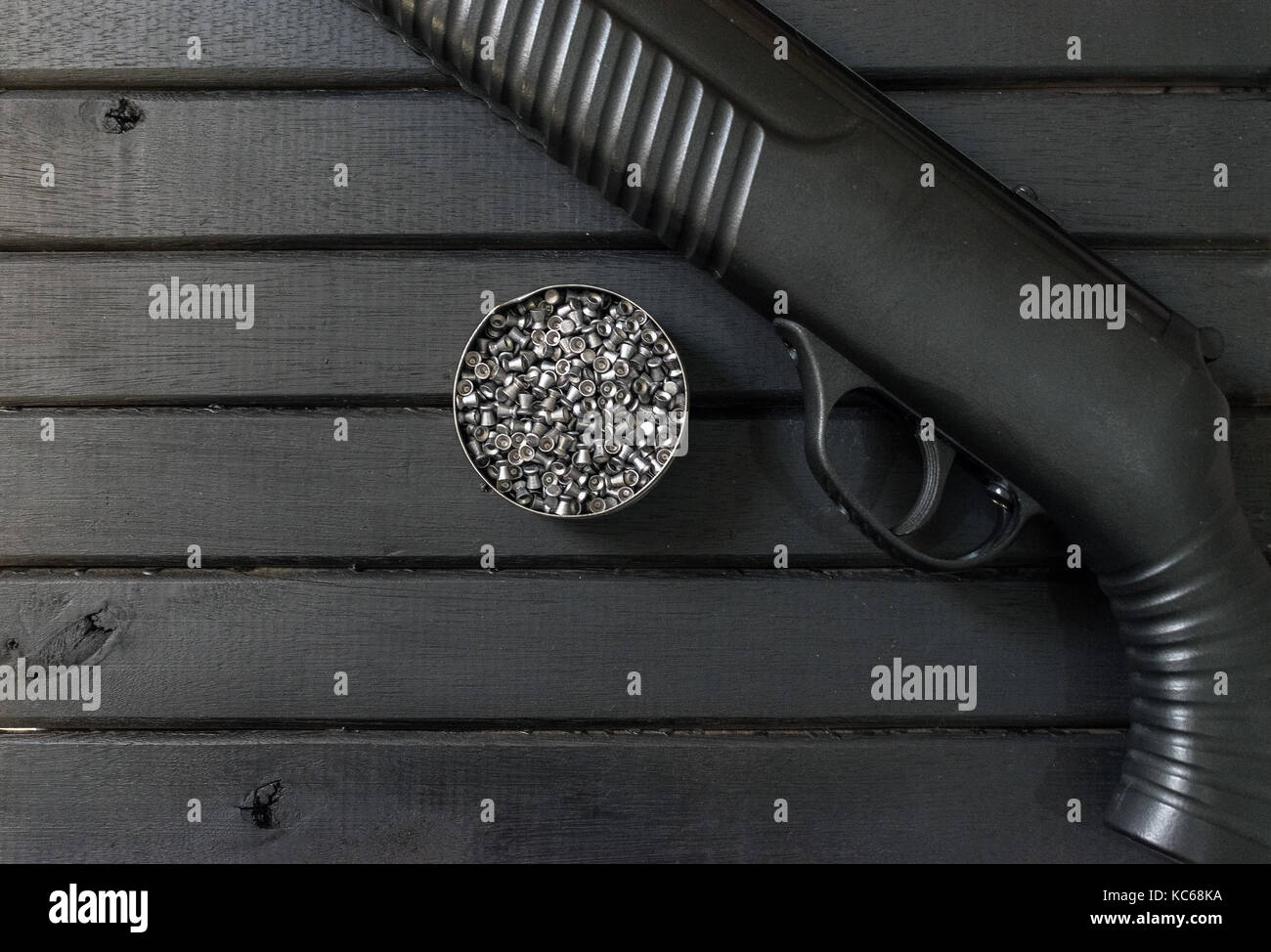 Polymer air rifle gun, on a black wooden background, closeup, showing ...