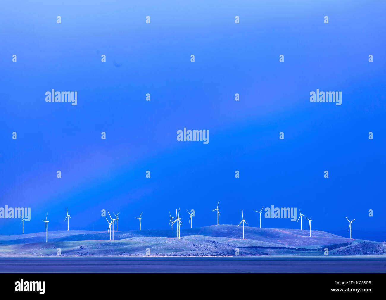 Storm clouds over wind vanes on hills at Lake George in NSW Stock Photo ...