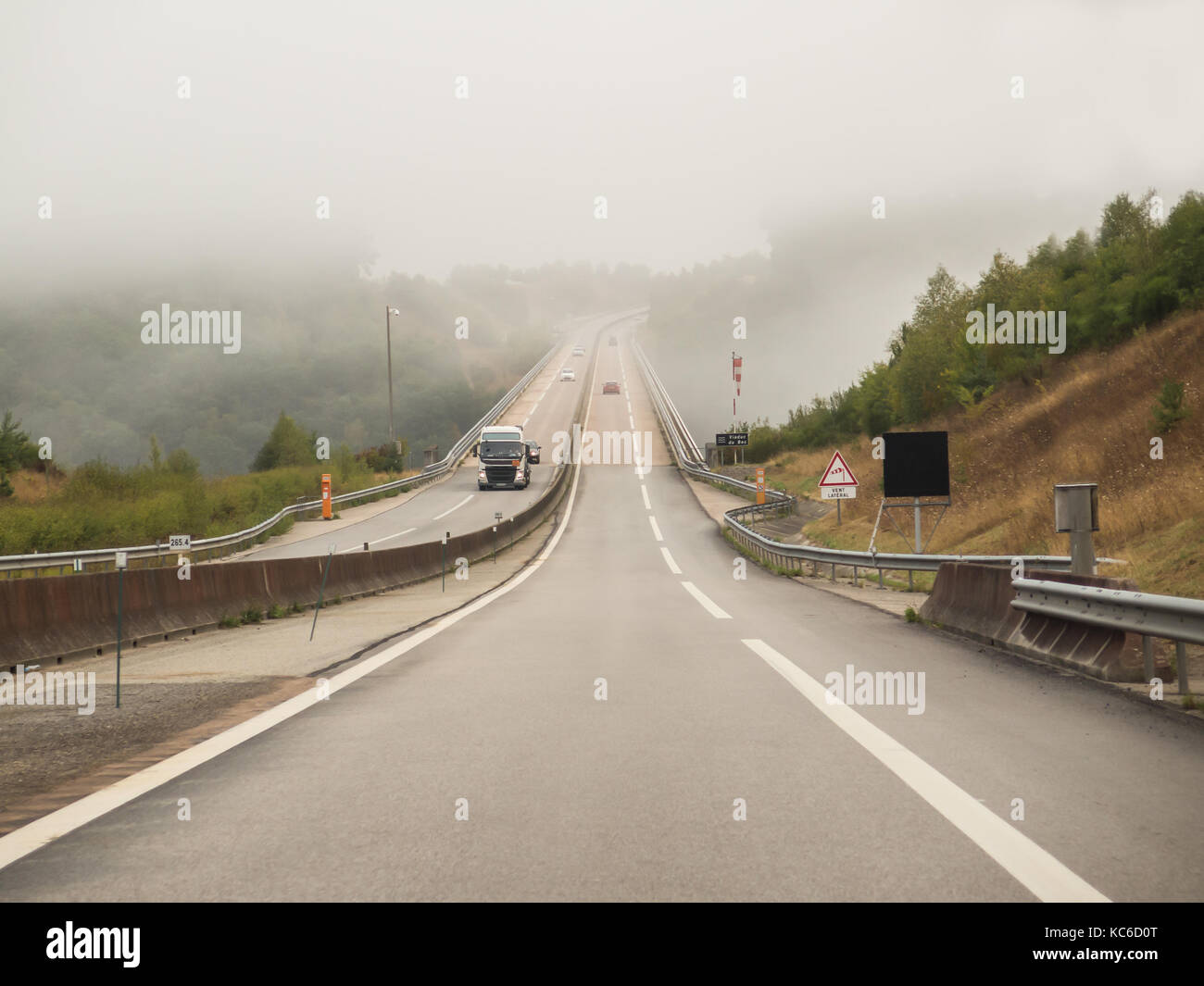 Misty, foggy morning causing difficult driving conditions on a road ...