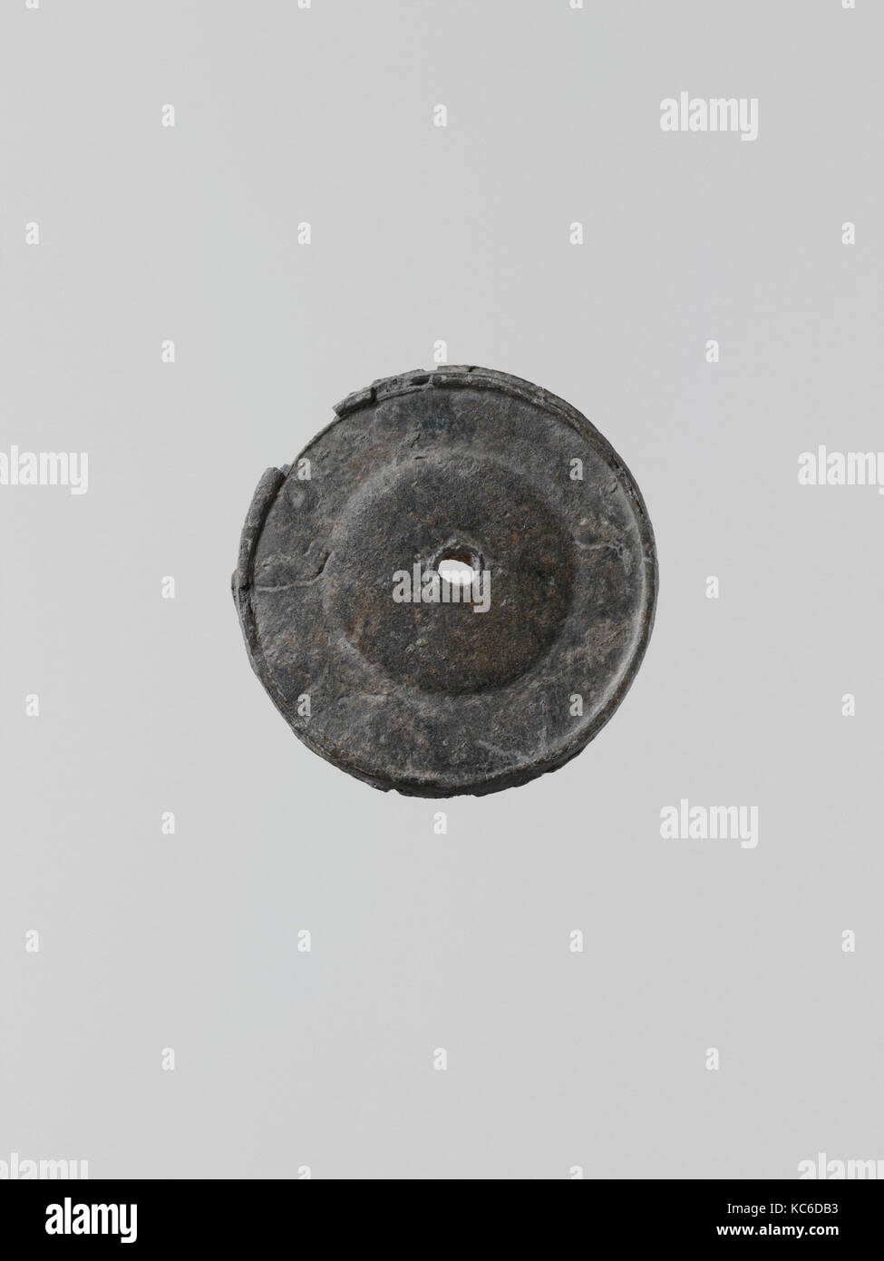 Lead disk with a hole in the center, 6th–5th century B.C Stock Photo ...