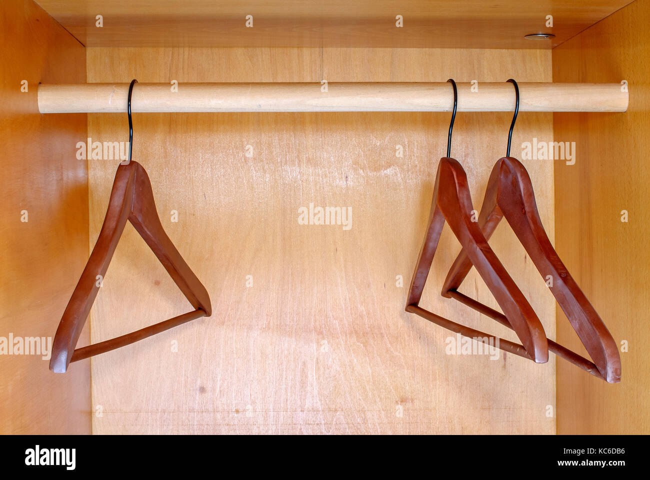 Empty hangers in wardrobe Stock Photo - Alamy