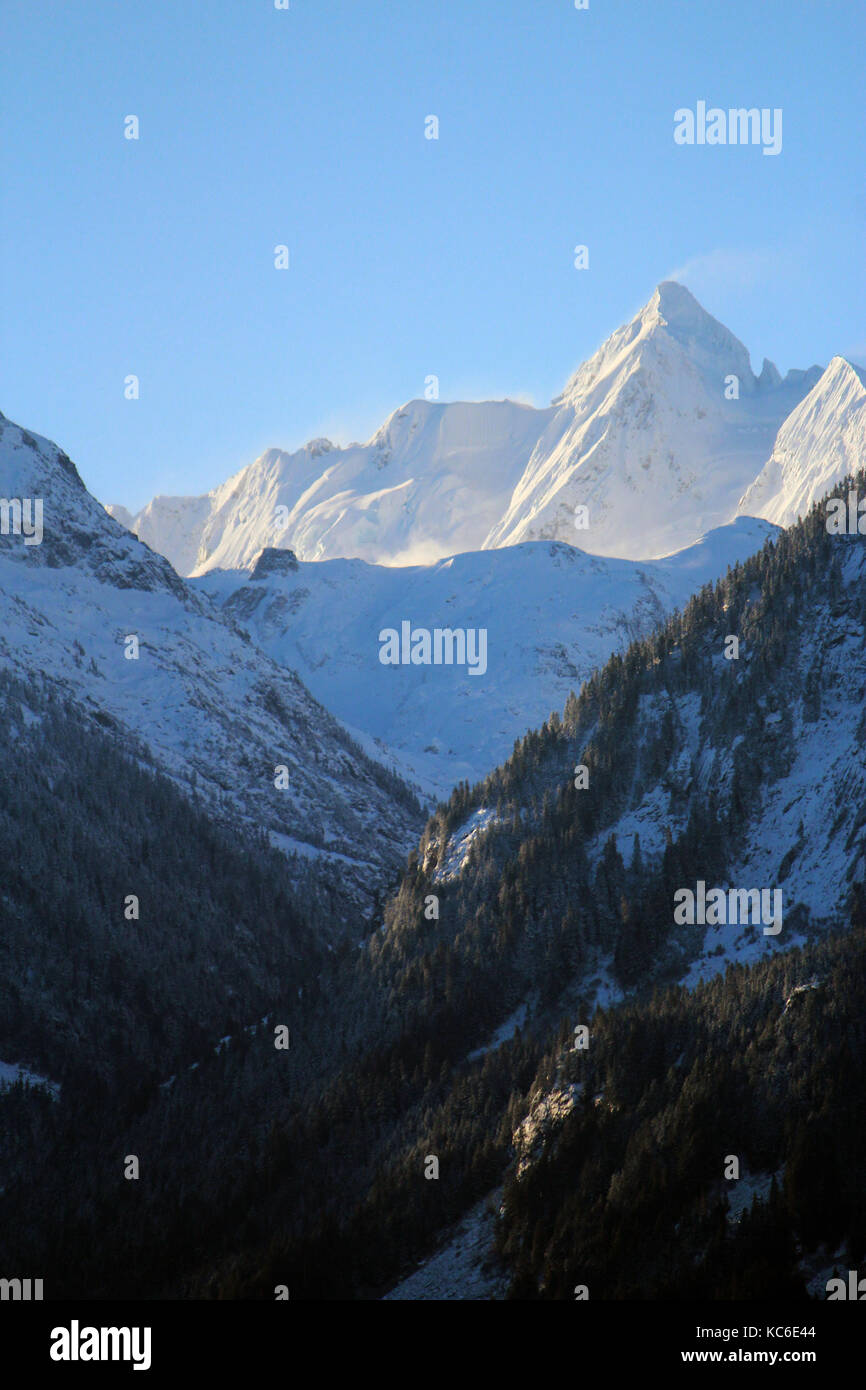 Snow capped mountain valley Stock Photo - Alamy