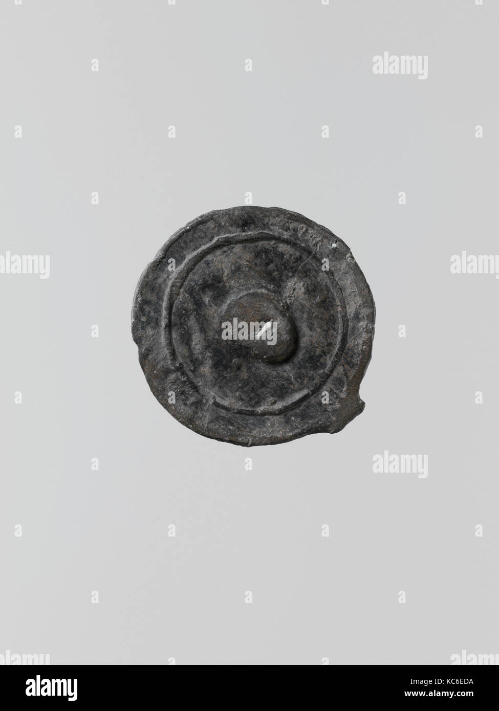 Lead disk with a hole in the center, 6th–5th century B.C Stock Photo ...