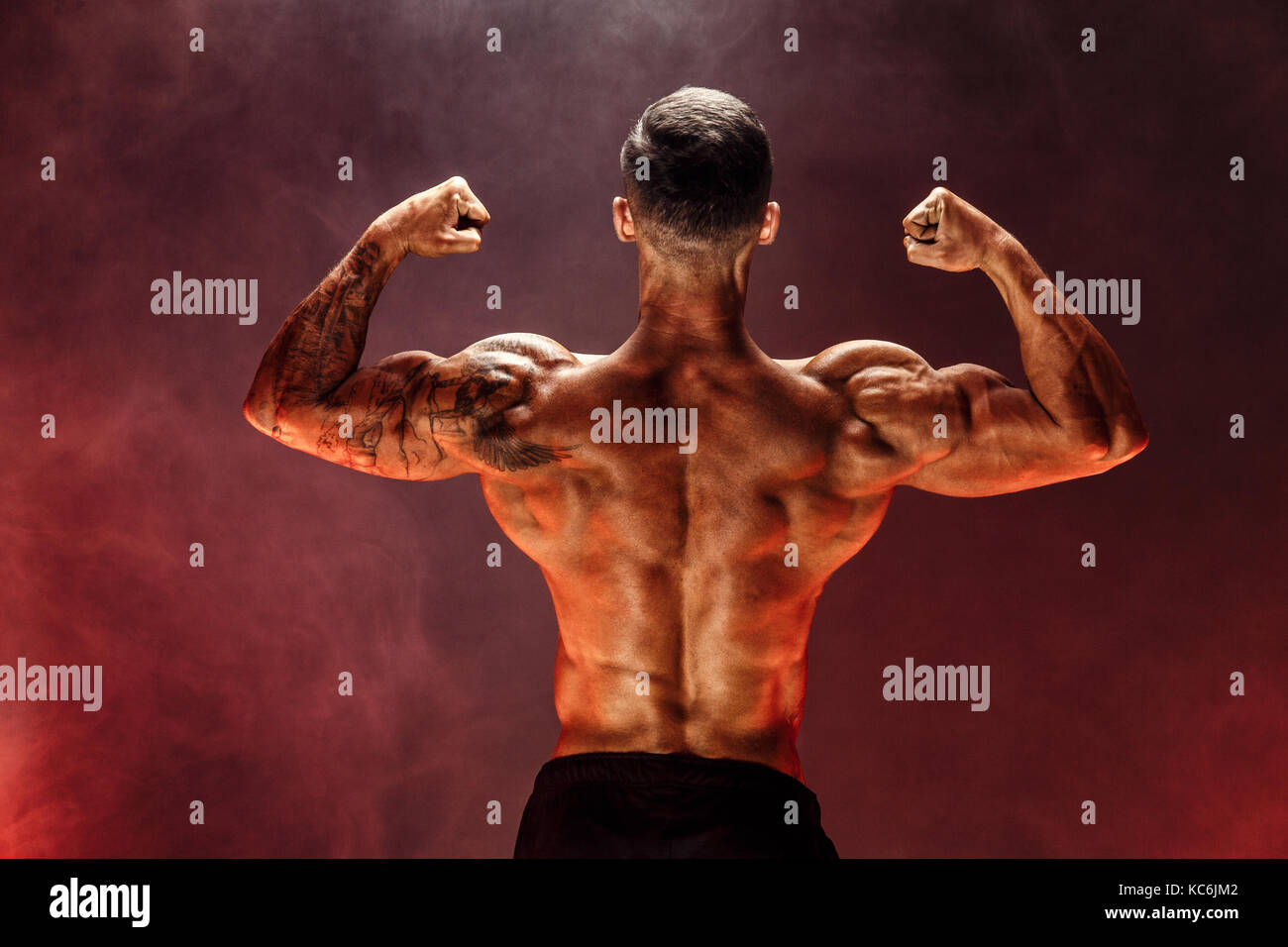 Bodybuilder Performing Rear Double Biceps Pose Stock Photo - Alamy