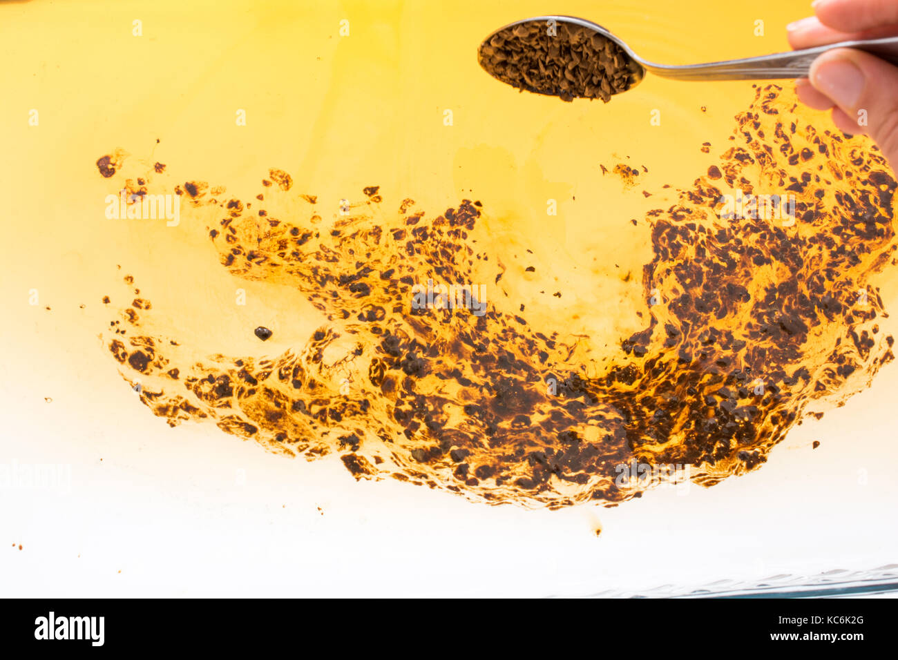 Coffe slowly dissolve in the hot water Stock Photo - Alamy