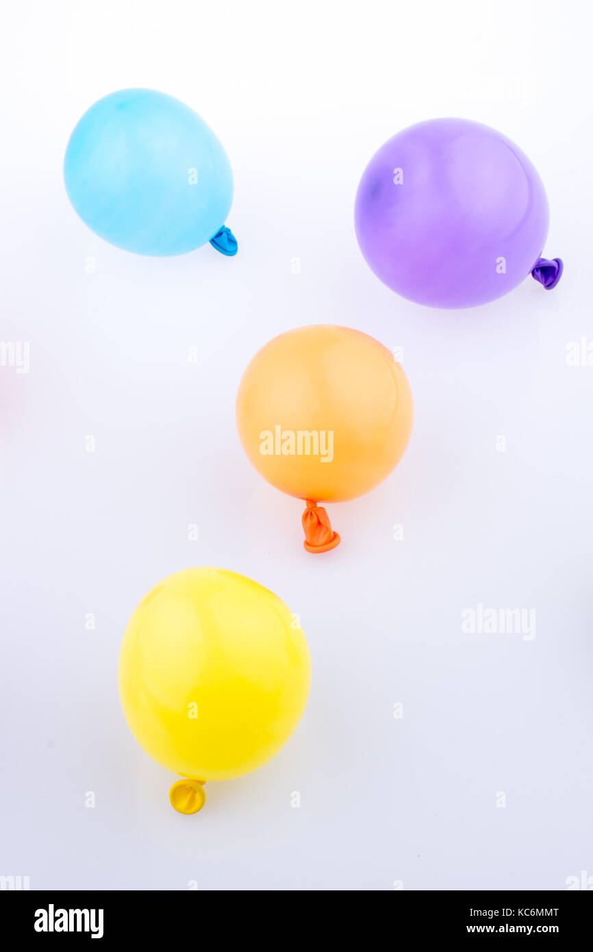 Colorful small balloons on a white background Stock Photo - Alamy