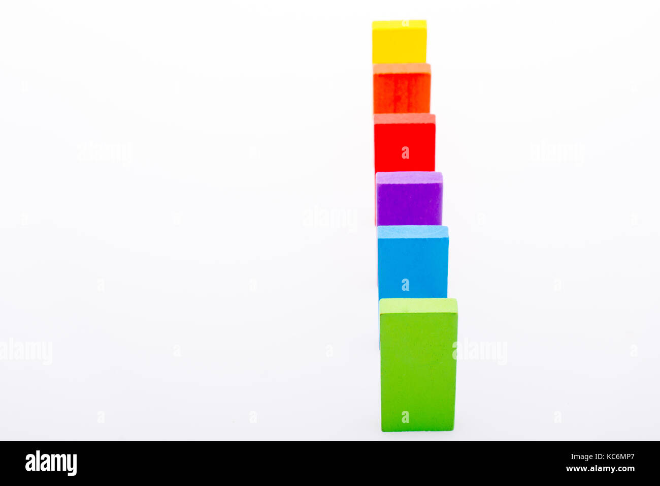 Colorful Domino Blocks in a line on a white background Stock Photo - Alamy