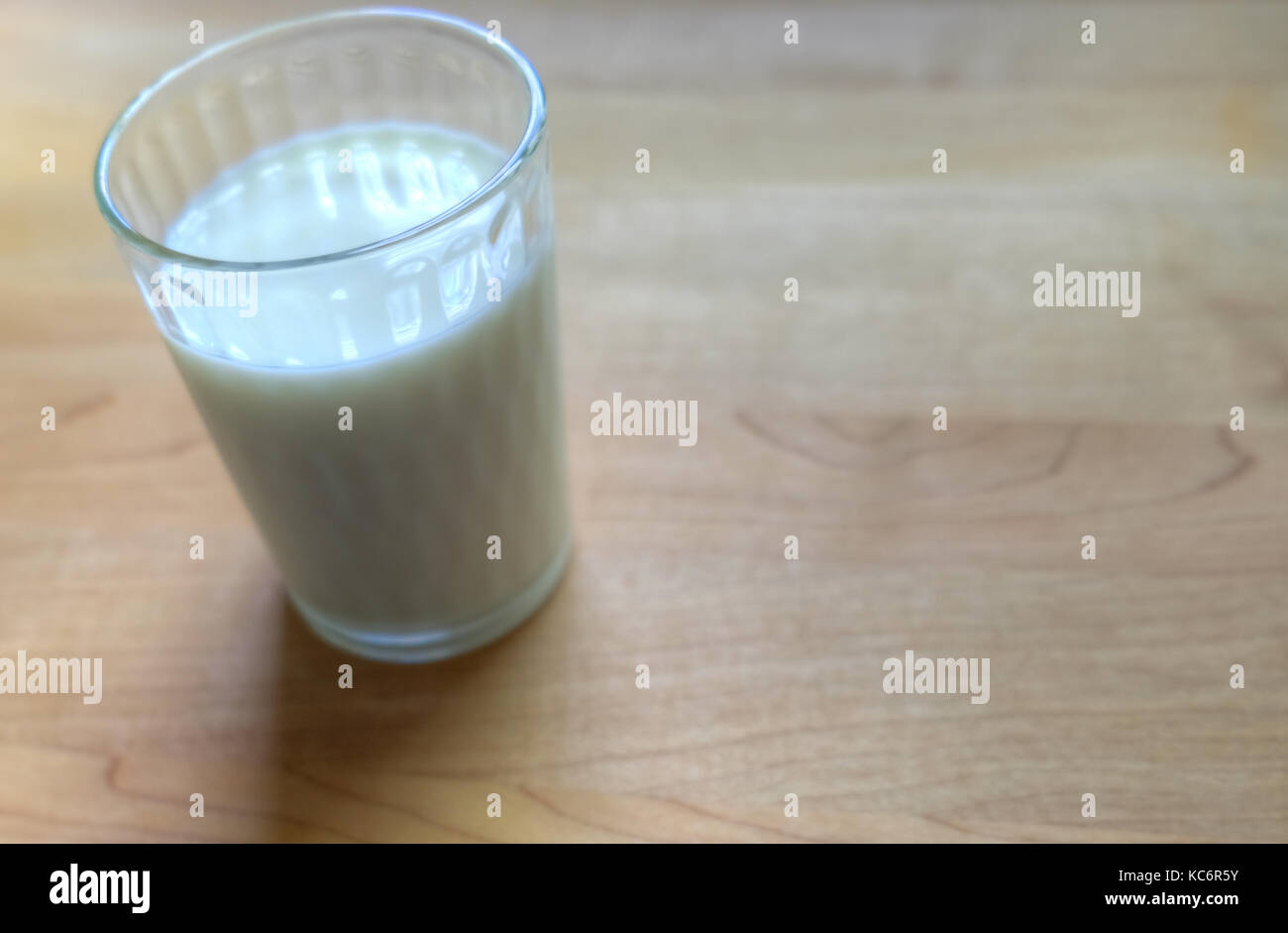 A glass of milk on a wood table Stock Photo - Alamy