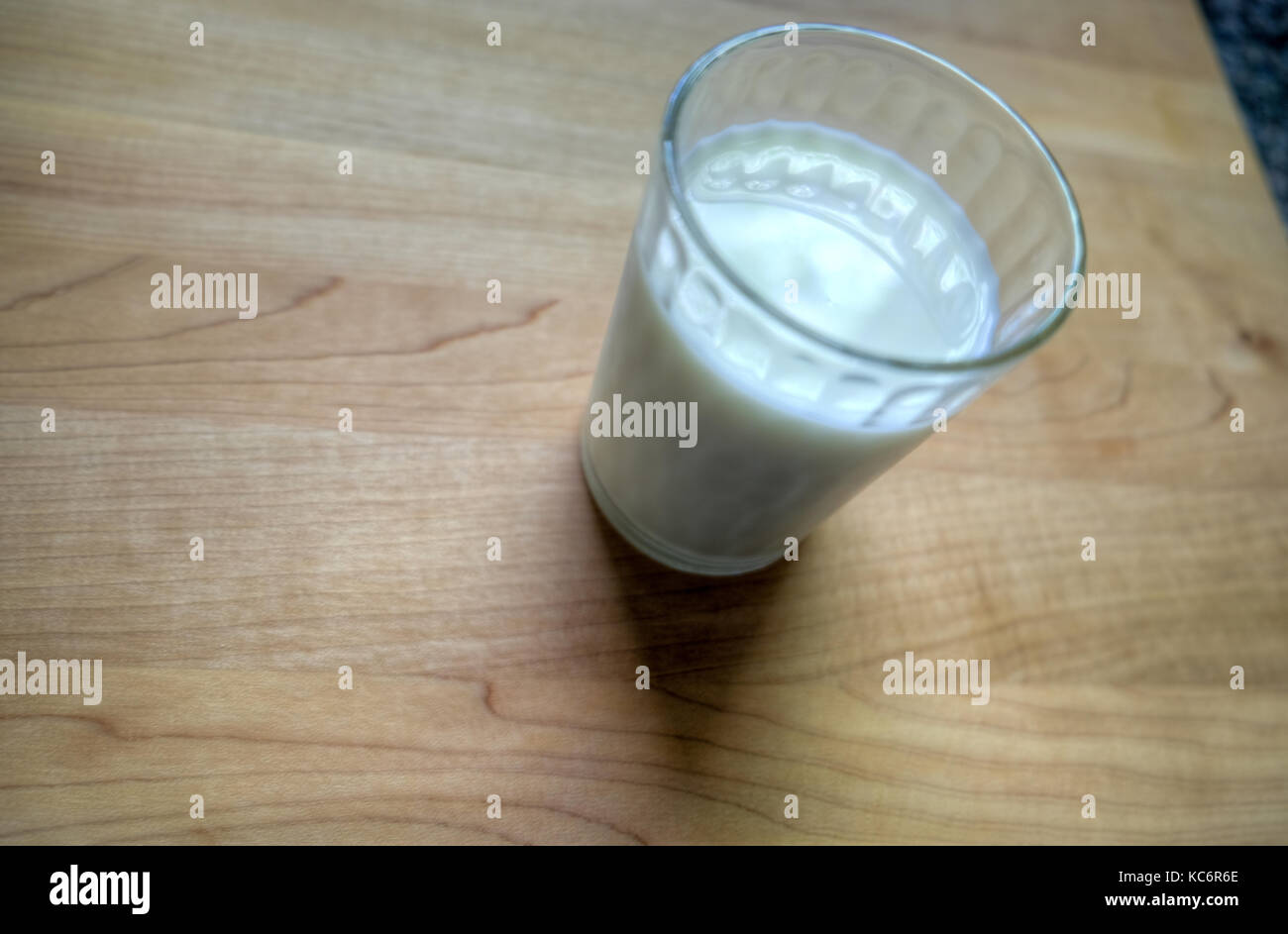 A glass of milk on a wood table Stock Photo - Alamy