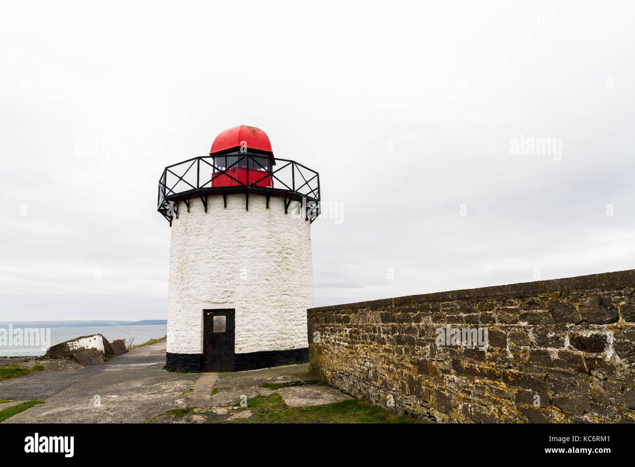 Small white squat white lighthouse with red top. Burry Port, Llanelli ...