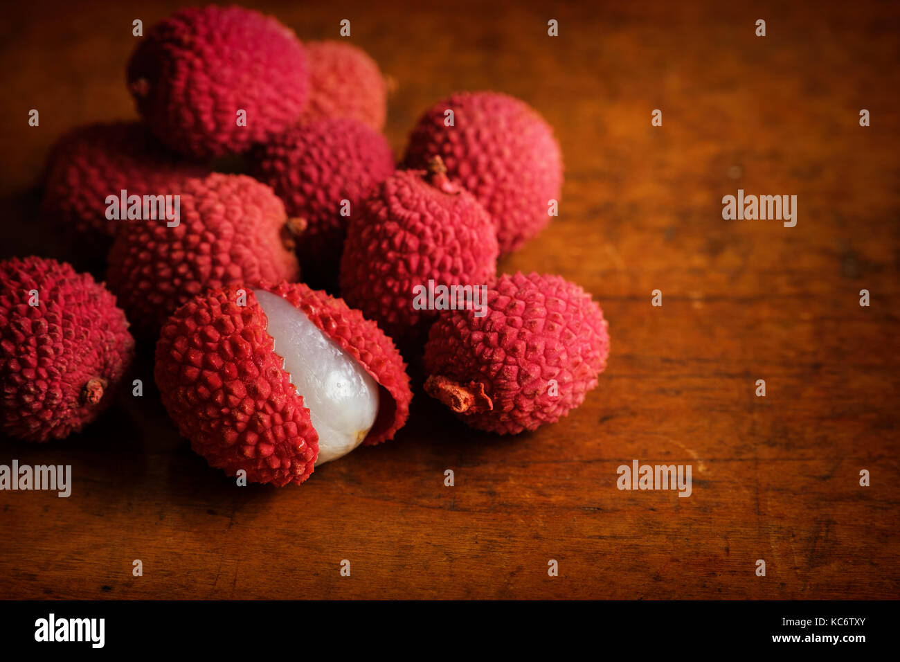 Organic lychee on wooden table Stock Photo - Alamy
