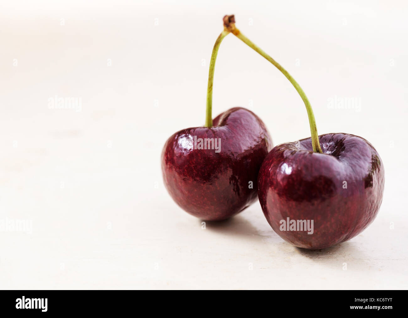 Shiny cherries on white background Stock Photo - Alamy
