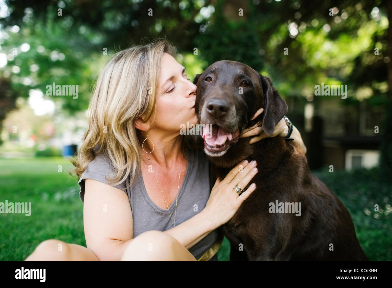 Portrait of woman kissing Labrador Retriever Stock Photo - Alamy