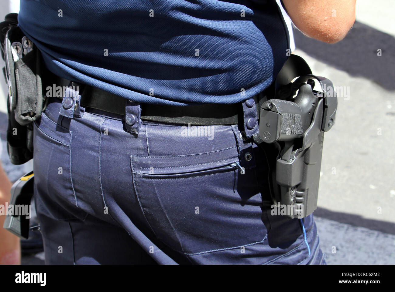 Close up of the hand gun worn in a holster by a French Police officer ...