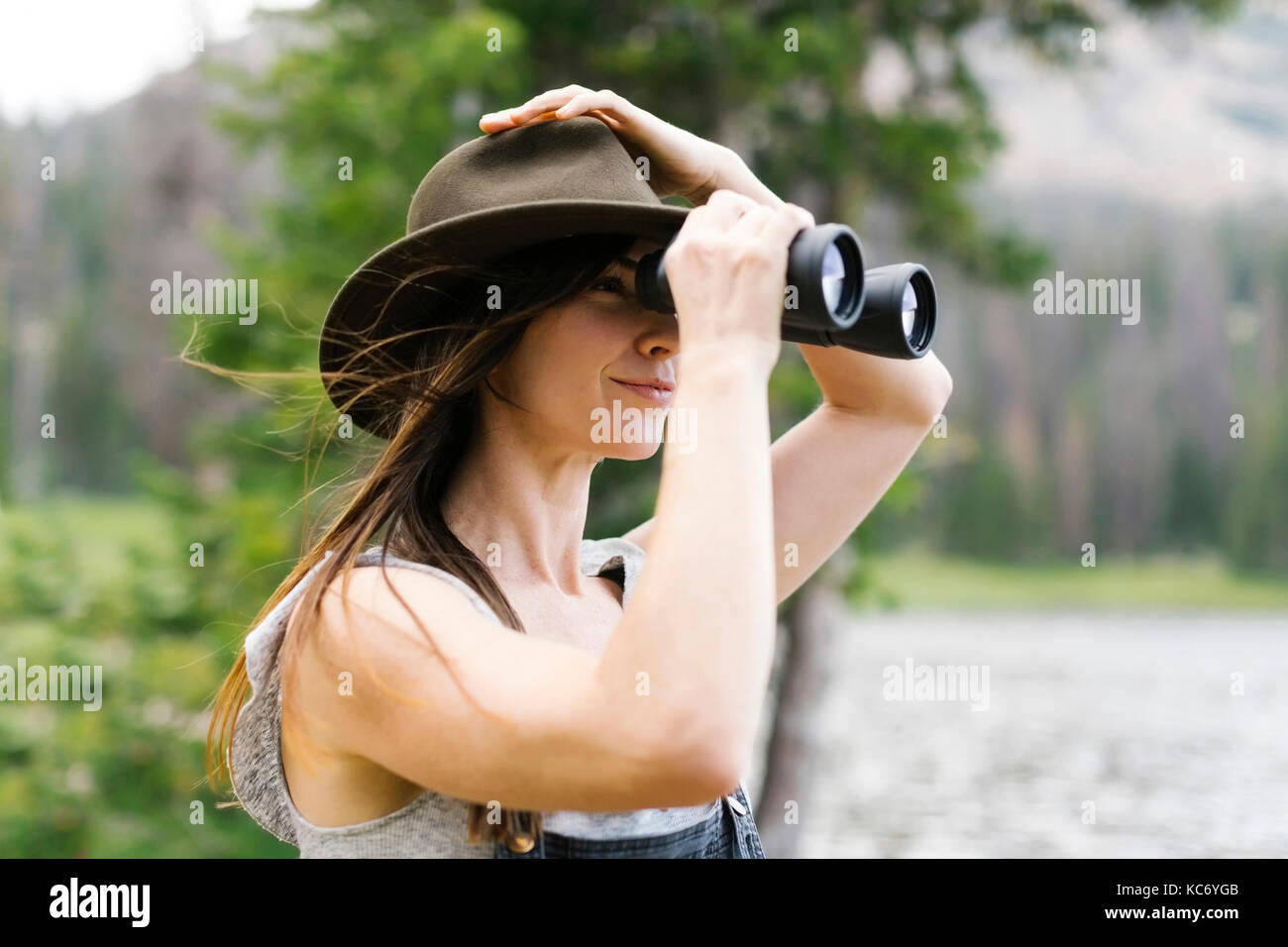 Woman using binoculars Stock Photo - Alamy