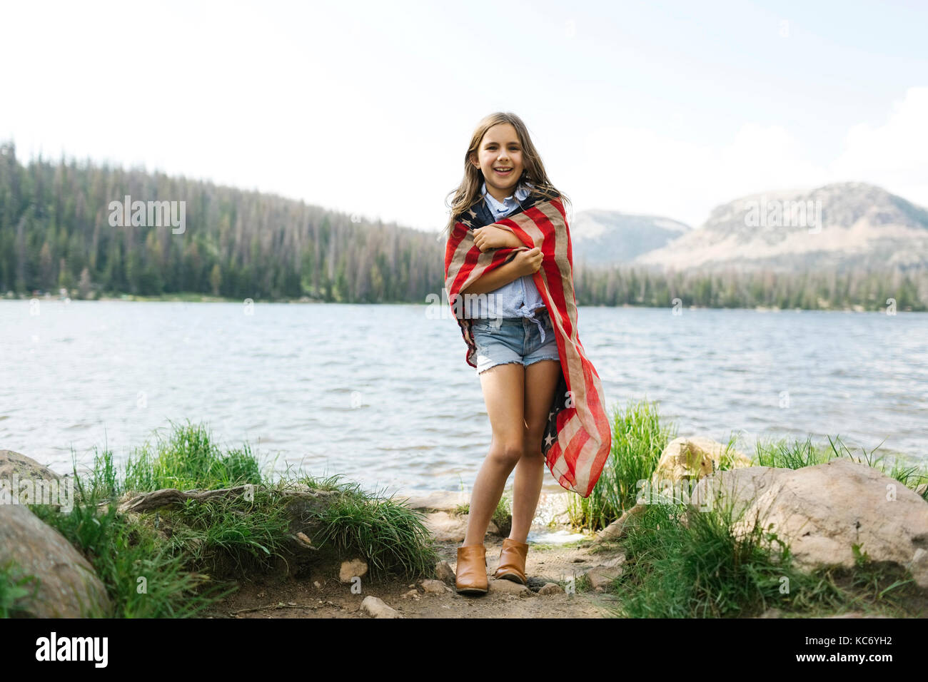 USA, Utah, Midway, Portrait of girl (8-9) wrapped in us flag standing ...