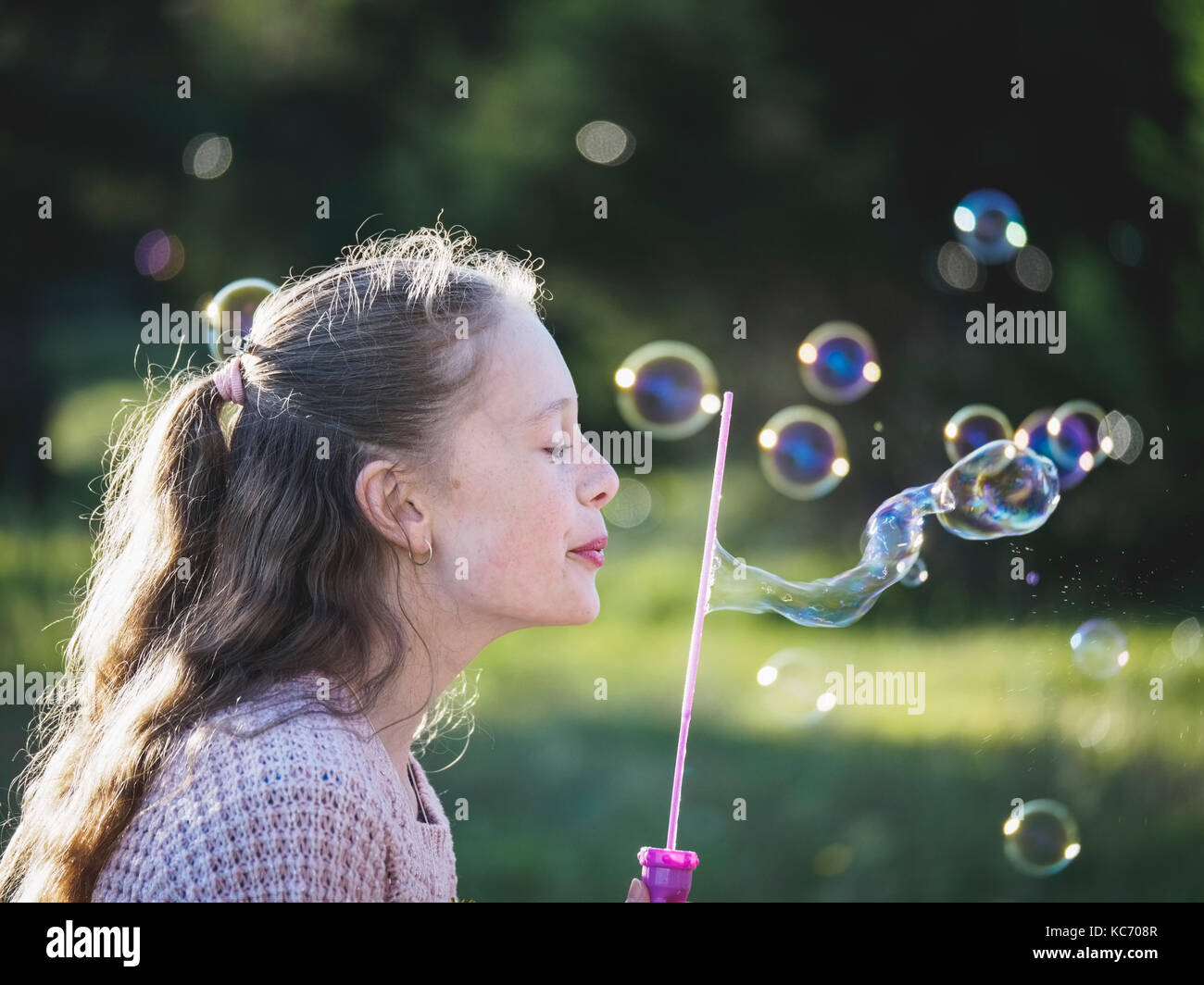 Girl (12-13) blowing bubbles Stock Photo - Alamy