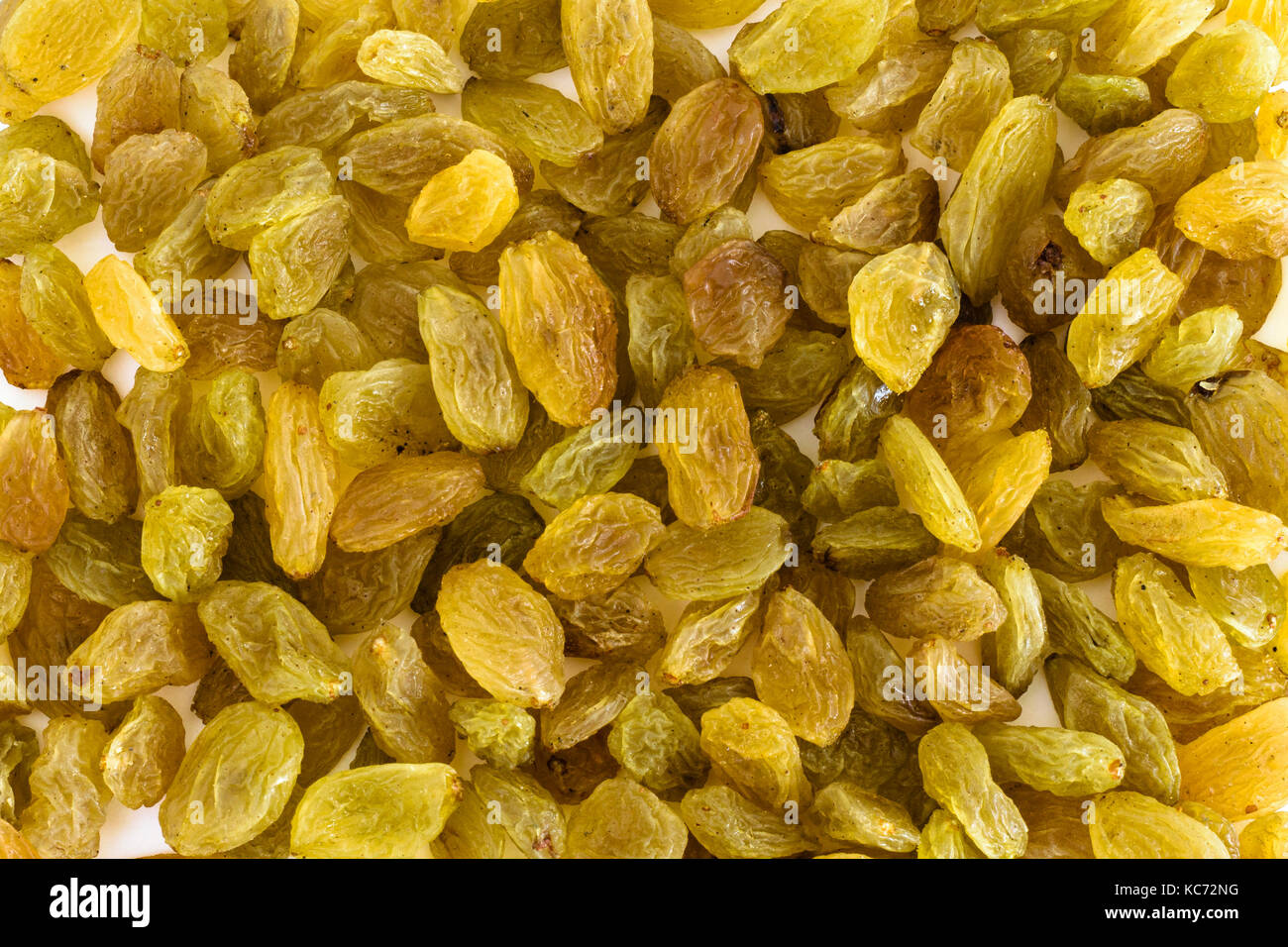 Golden yellow raisins filled in as background Stock Photo - Alamy
