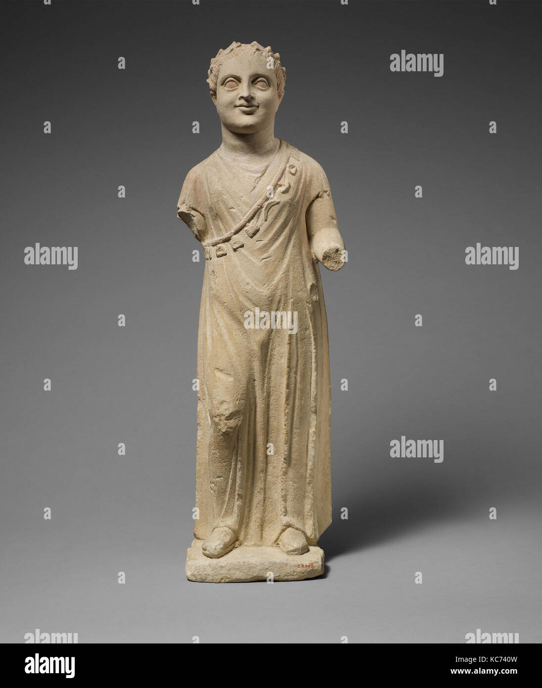 Limestone statuette of a boy with a chain of amulets, late 4th century ...