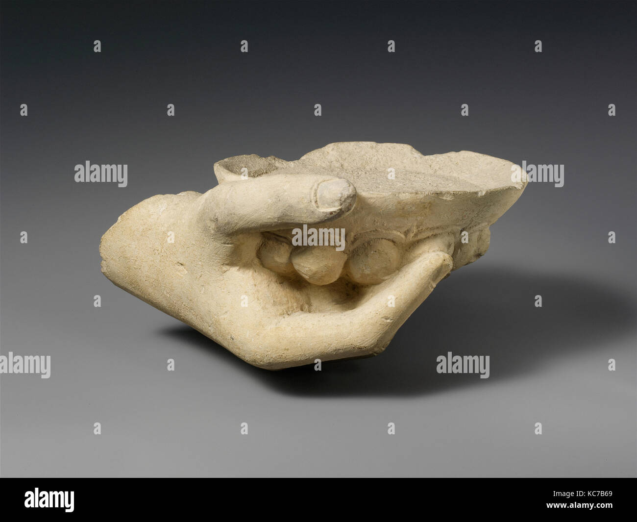 Limestone statue fragment of a right hand holding a phiale (libation ...