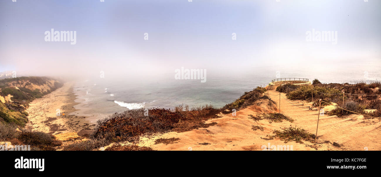 Fog drifts in over the ocean at Crystal Cove state beach on the edge of ...