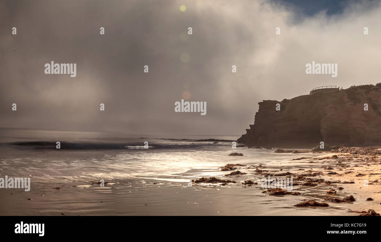 Fog drifts in over the ocean at Crystal Cove state beach on the edge of ...