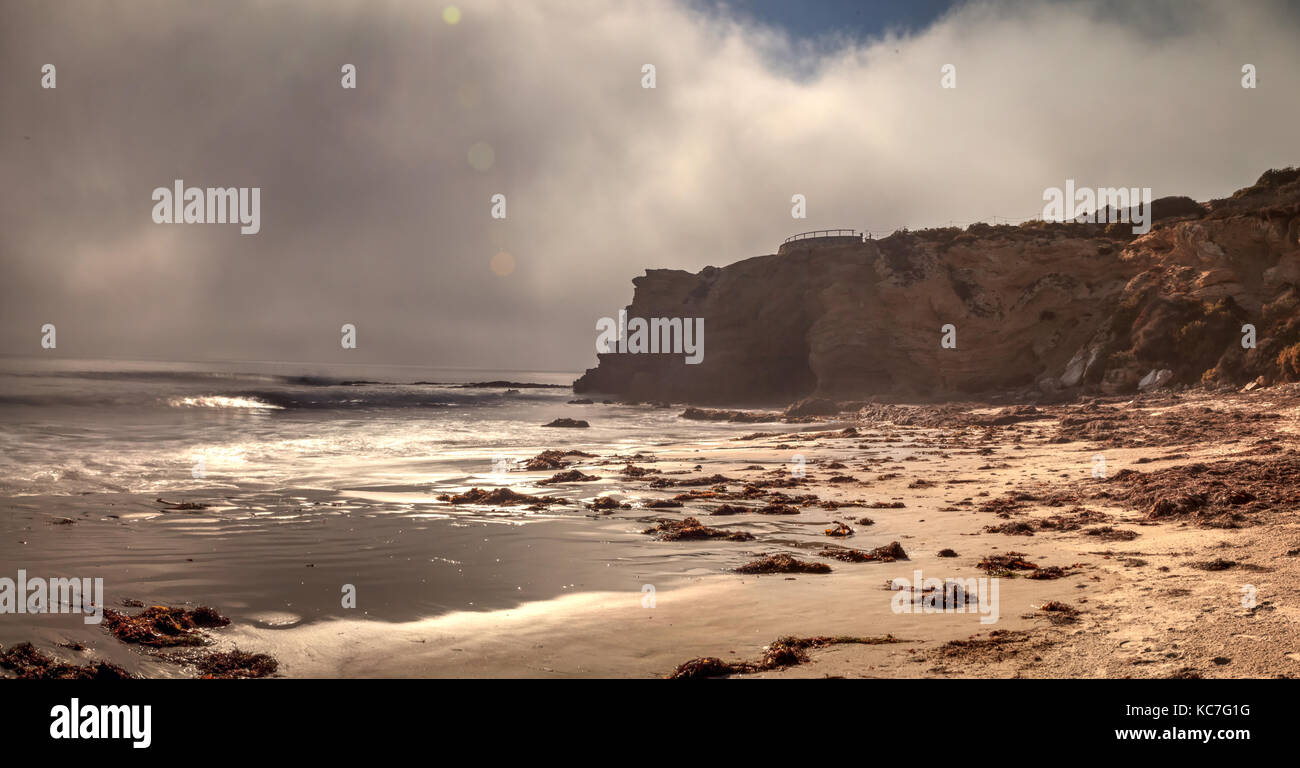 Fog drifts in over the ocean at Crystal Cove state beach on the edge of ...