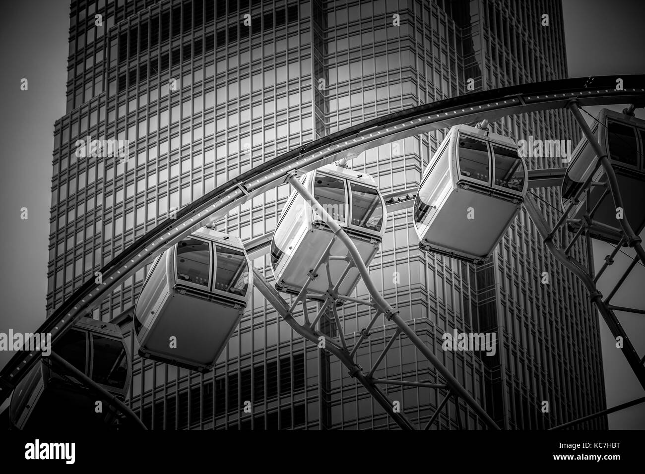 Ferris Wheel against commercial building Stock Photo - Alamy