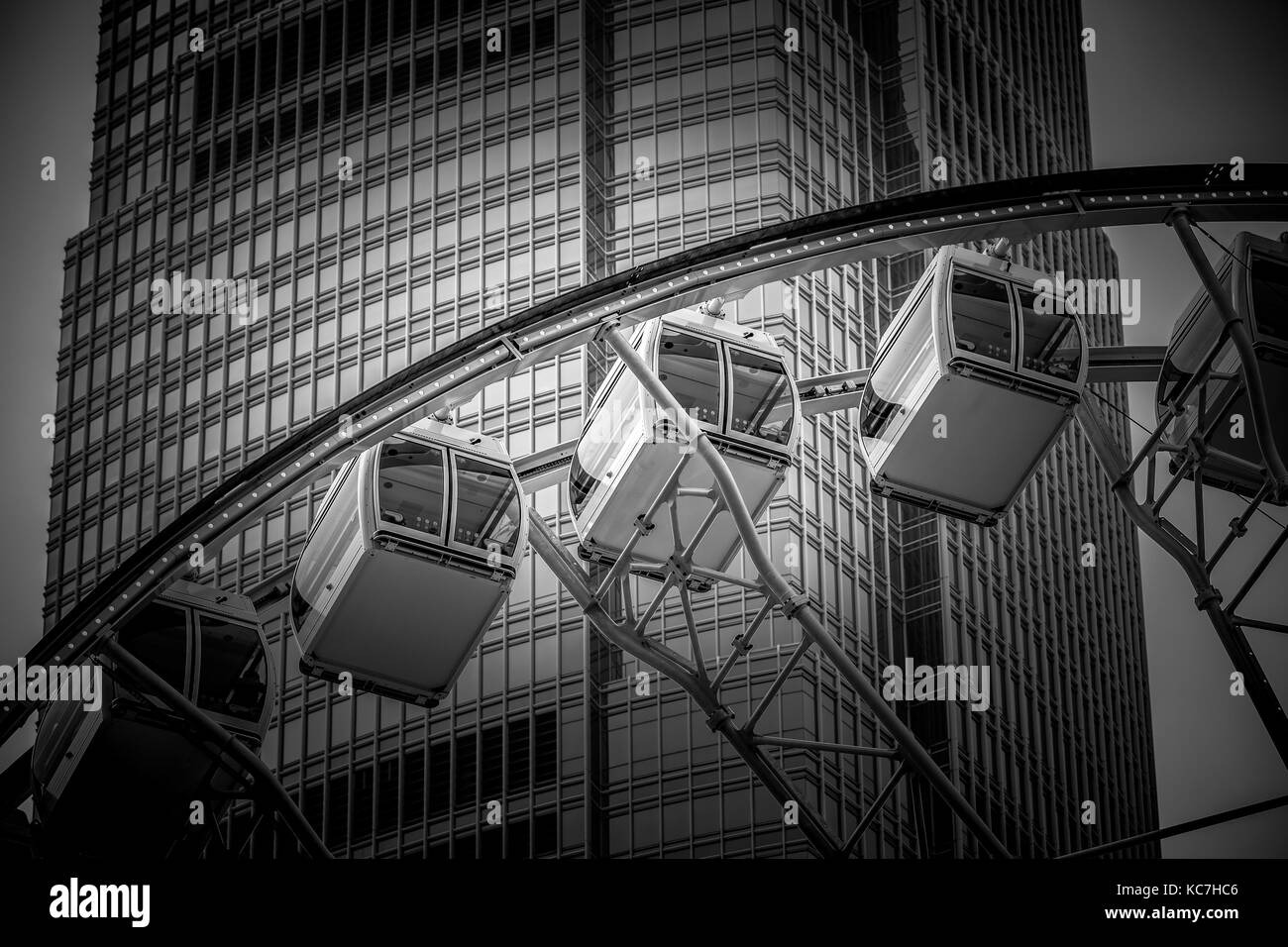 Ferris Wheel against commercial building Stock Photo - Alamy