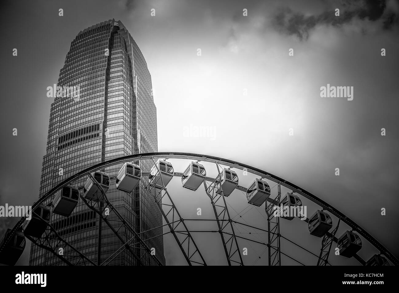 Ferris Wheel against commercial building Stock Photo - Alamy