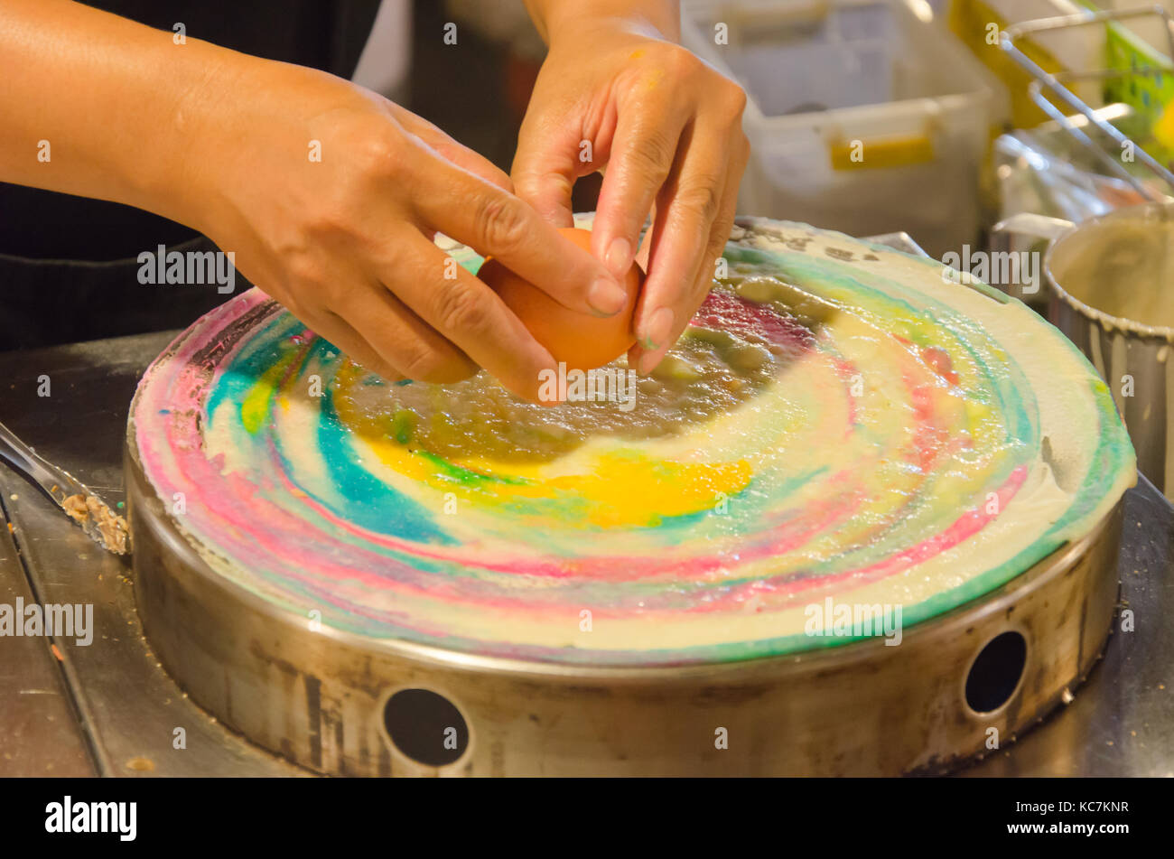 crepe spreading with egg,Rainbow crepe flour Stock Photo - Alamy