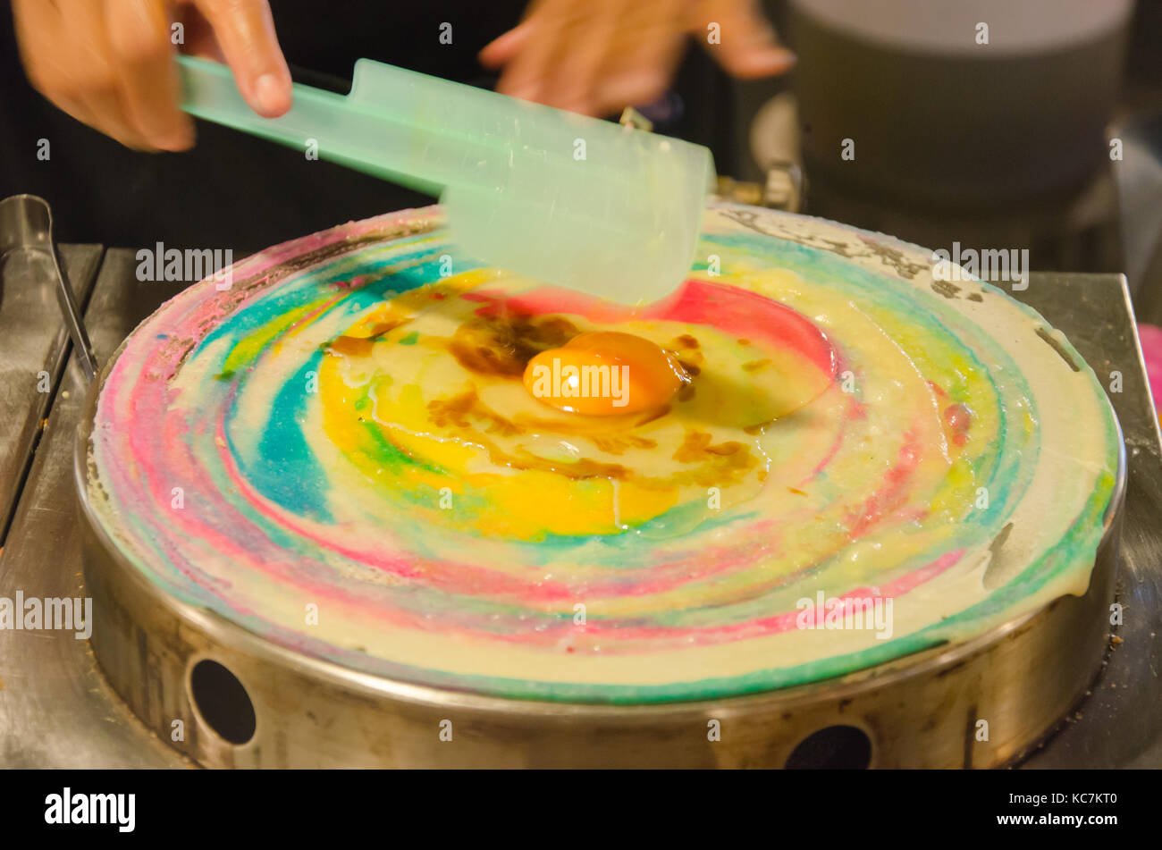 crepe spreading with egg,Rainbow crepe flour Stock Photo - Alamy