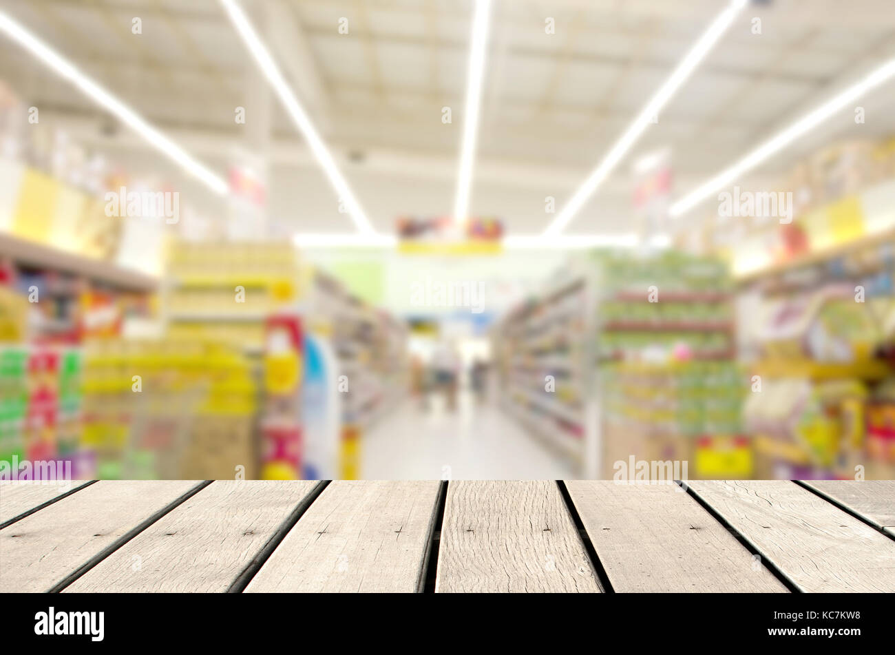Wood table top Abstract blur image Department of candy and snacks for ...