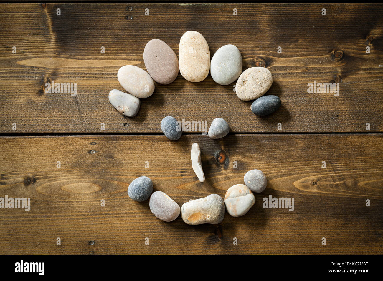 Face made from beach pebbles with a happy smiling expression on a ...