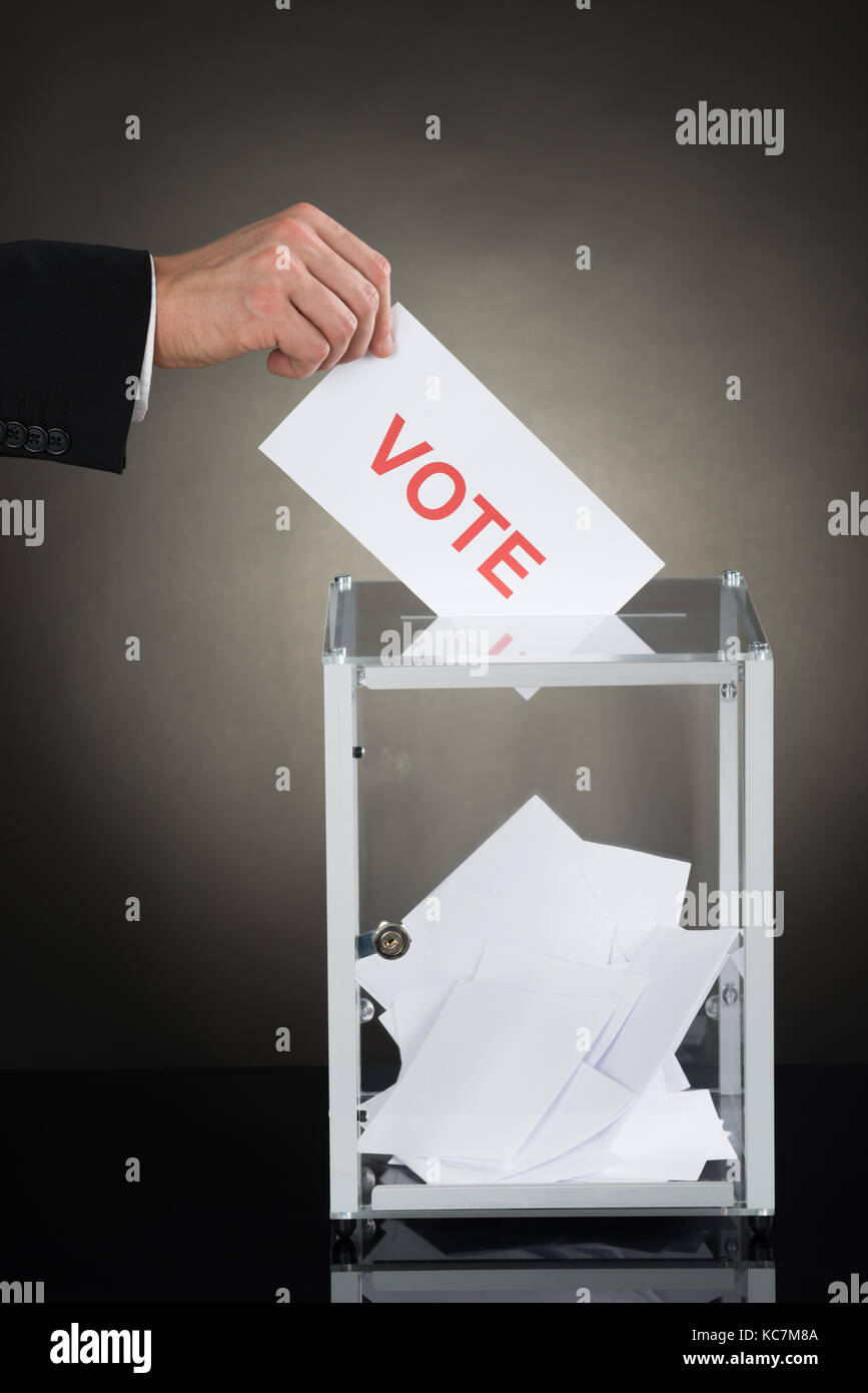Close-up Of A Businessperson Hand Putting Vote Into Ballot Box Stock ...