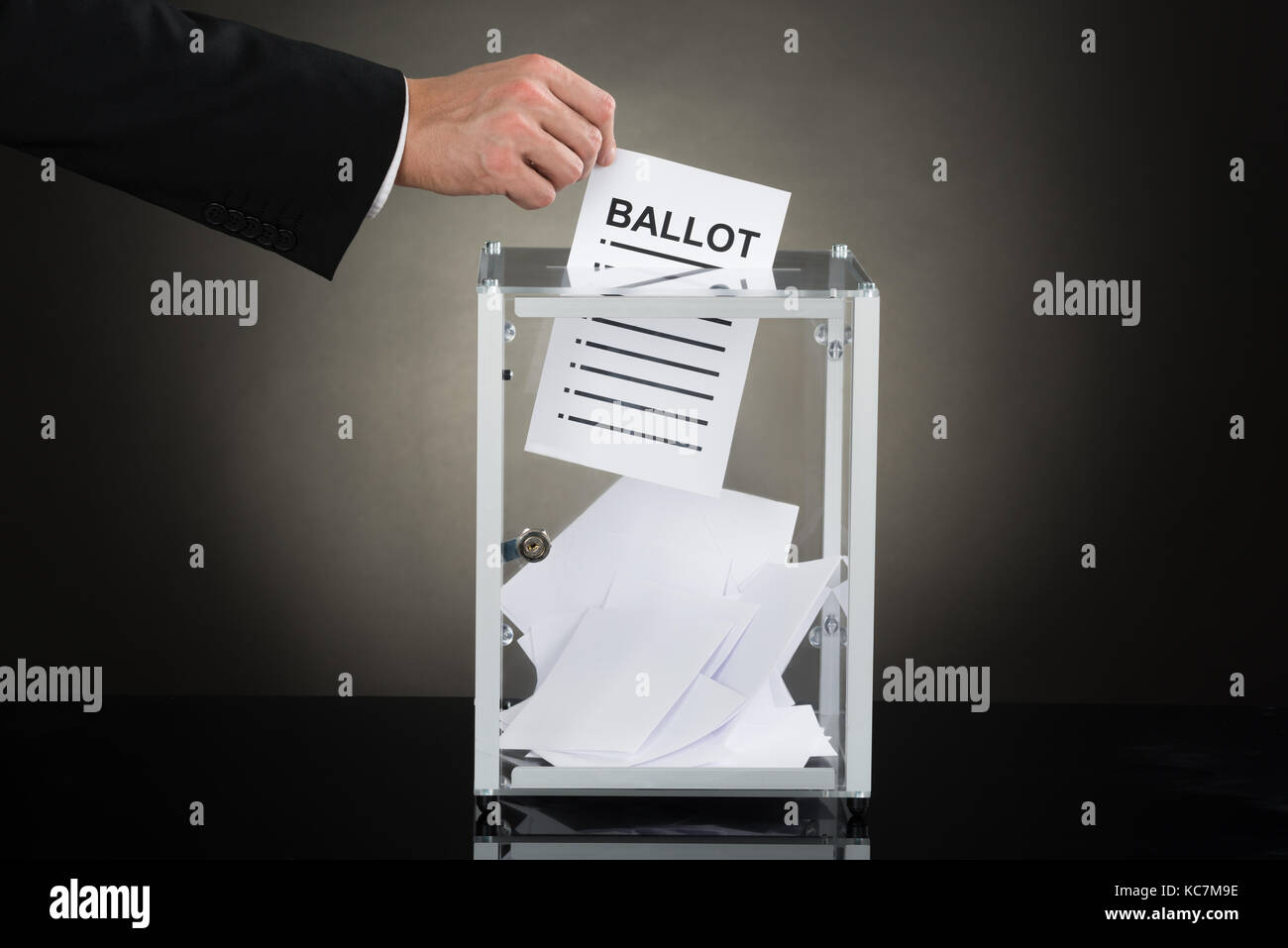 Close-up Of A Businessperson Hand Putting Ballot In Glass Box Stock ...