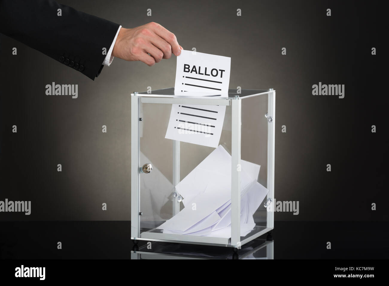 Close-up Of A Businessperson Hand Putting Ballot In Glass Box Stock ...