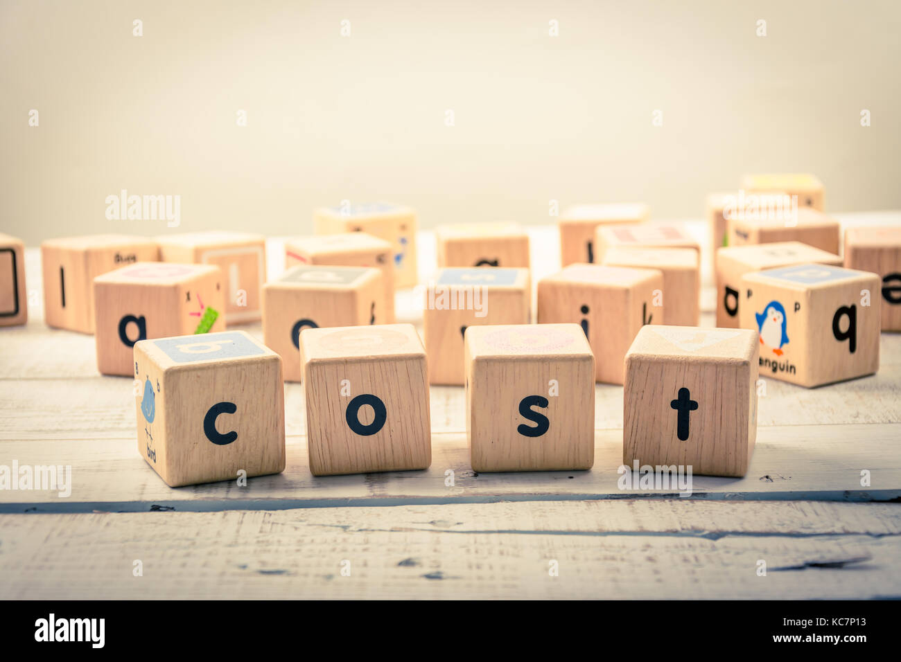 Word 'cost ' wood Cubic on the wood Stock Photo - Alamy
