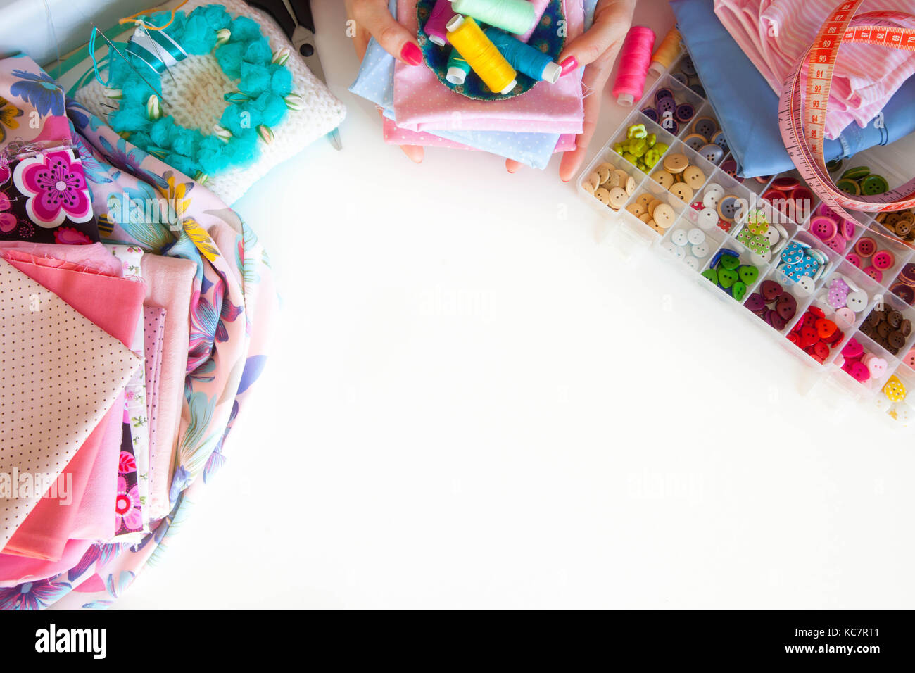 Female hands and accessories for sewing. Buttons, fabric and thread ...