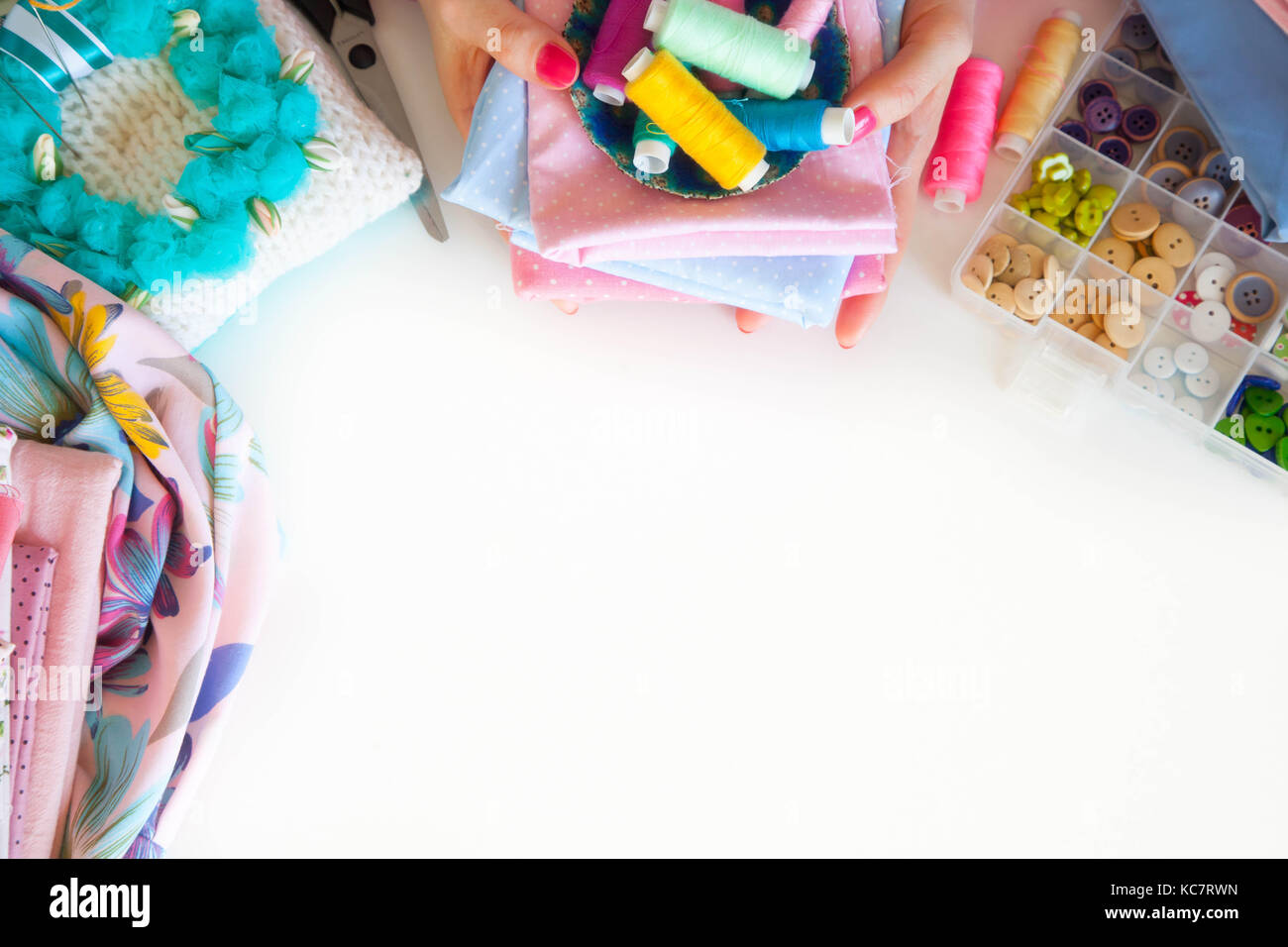 Female hands and accessories for sewing. Buttons, fabric and thread ...