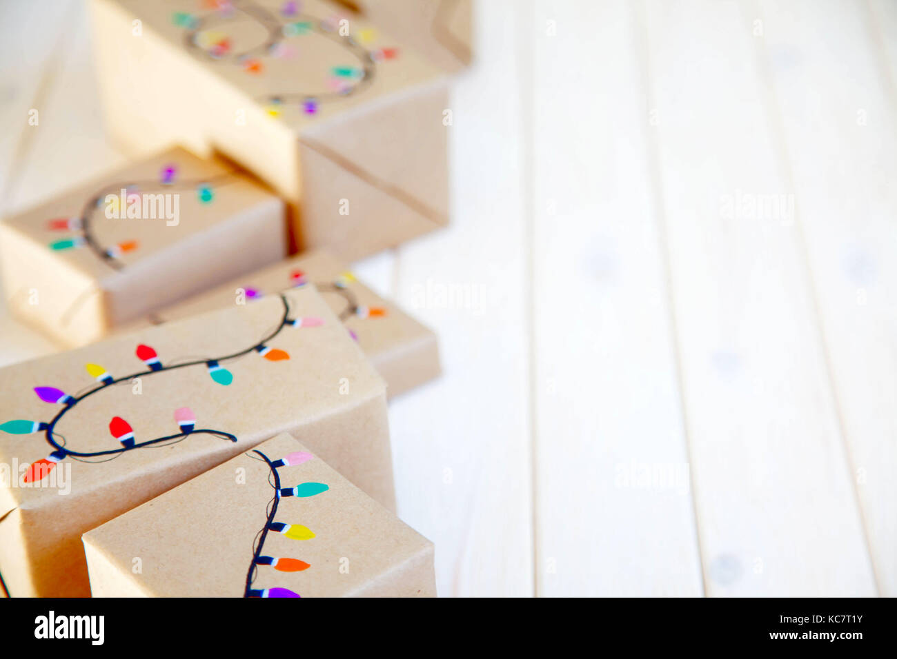 Gift boxes with festive garlands Stock Photo - Alamy