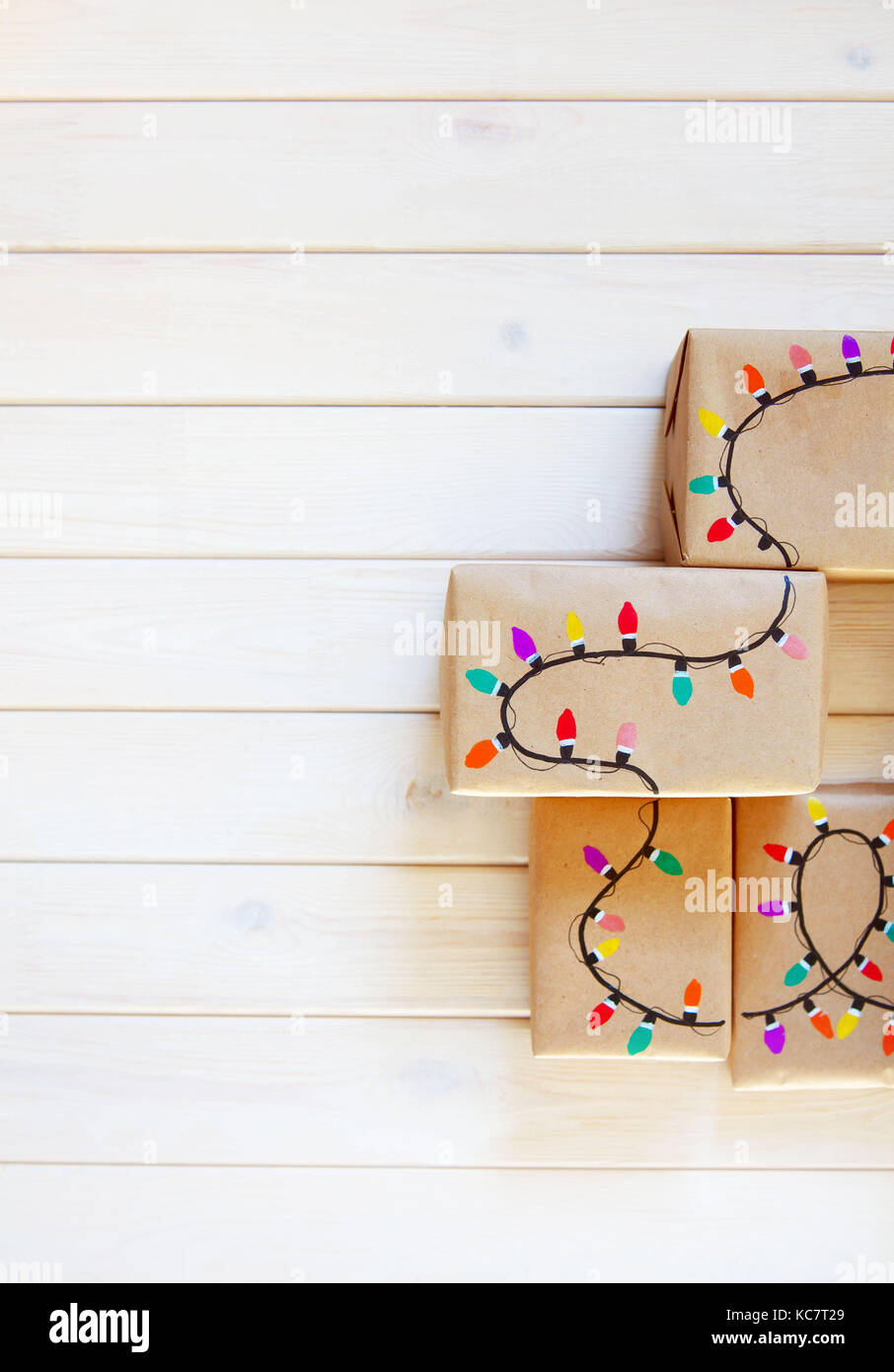 Gift boxes with festive garlands Stock Photo - Alamy