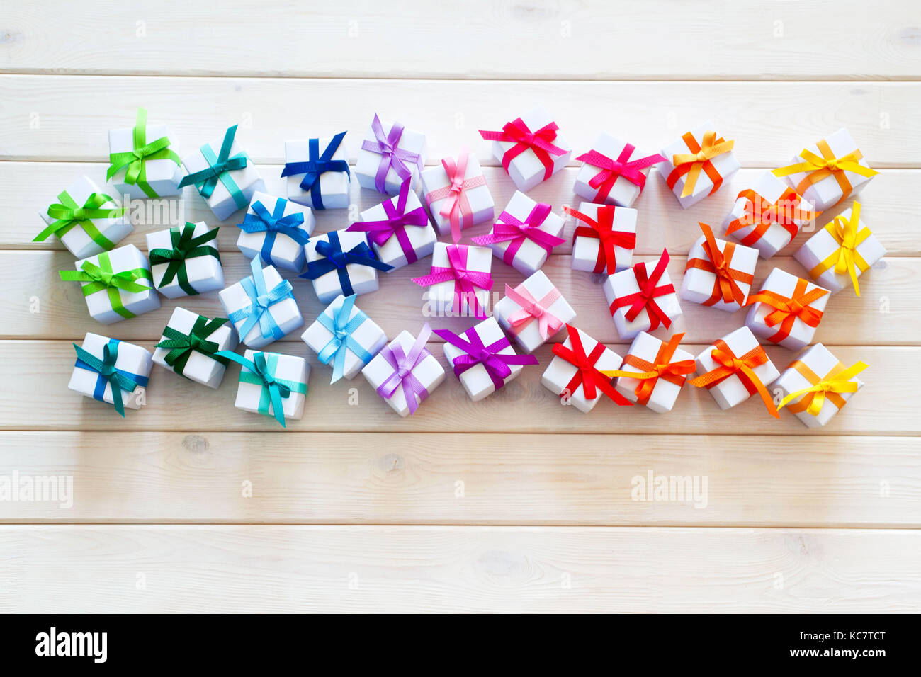 A lot of small gifts with color ribbons Stock Photo - Alamy