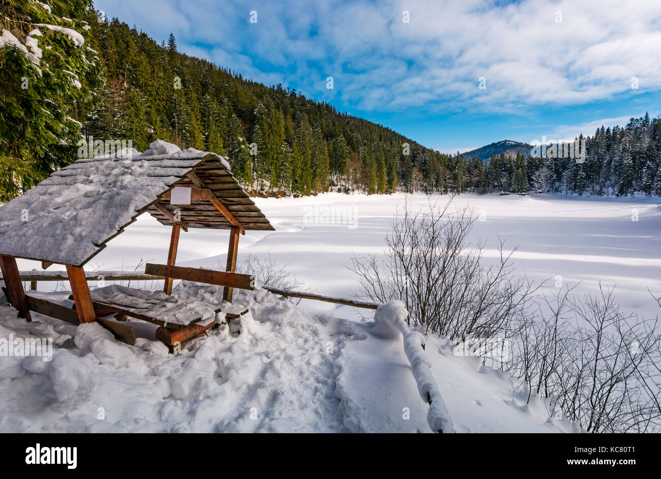 wooden bower in snowy winter spruce forest. beautiful mountainous ...