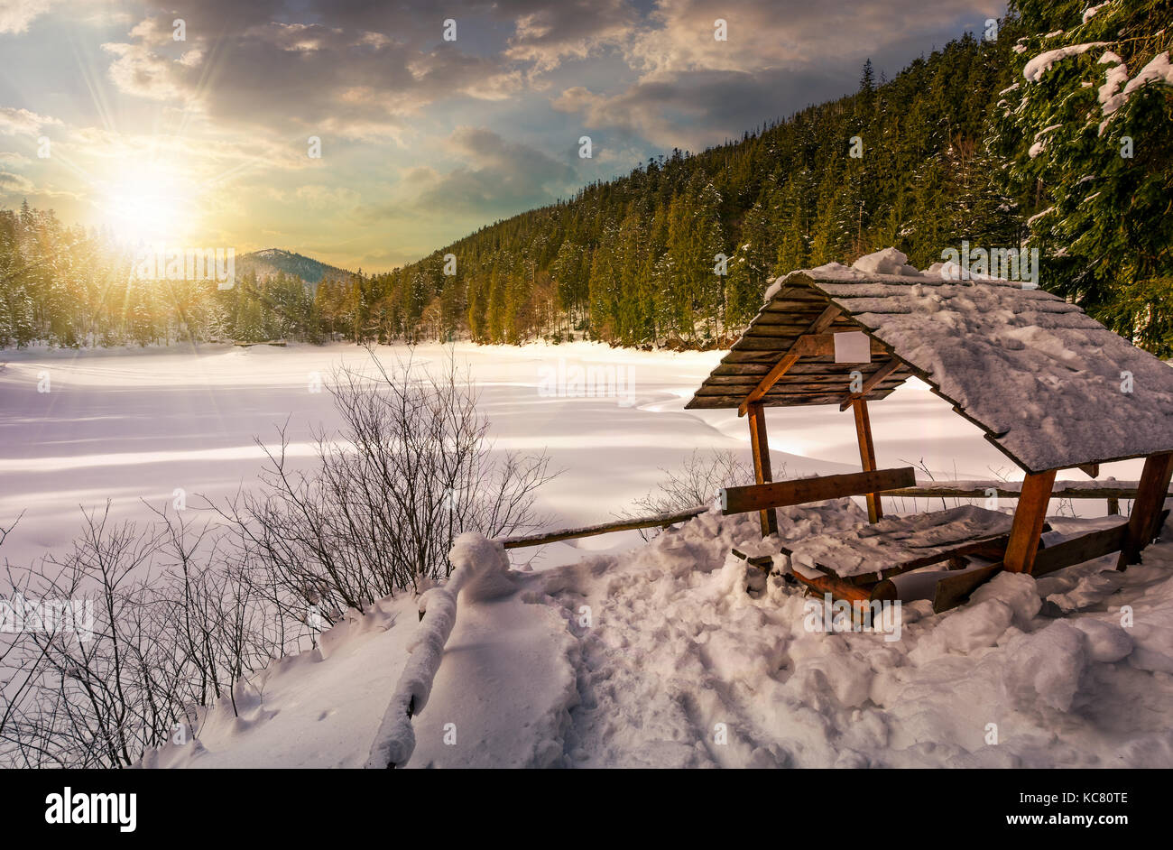 wooden bower in snowy winter spruce forest. beautiful mountainous ...